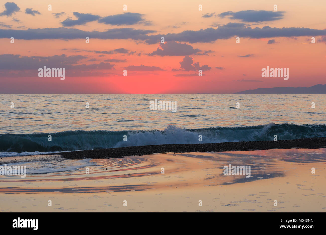 Sunset on sea beach Stock Photo - Alamy