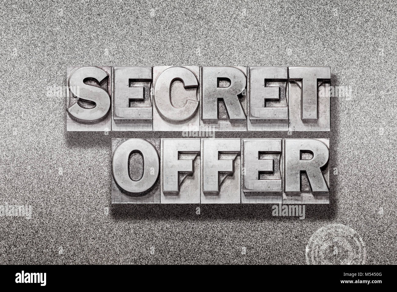 secret offer phrase made from vintage letterpress on metallic textured ...