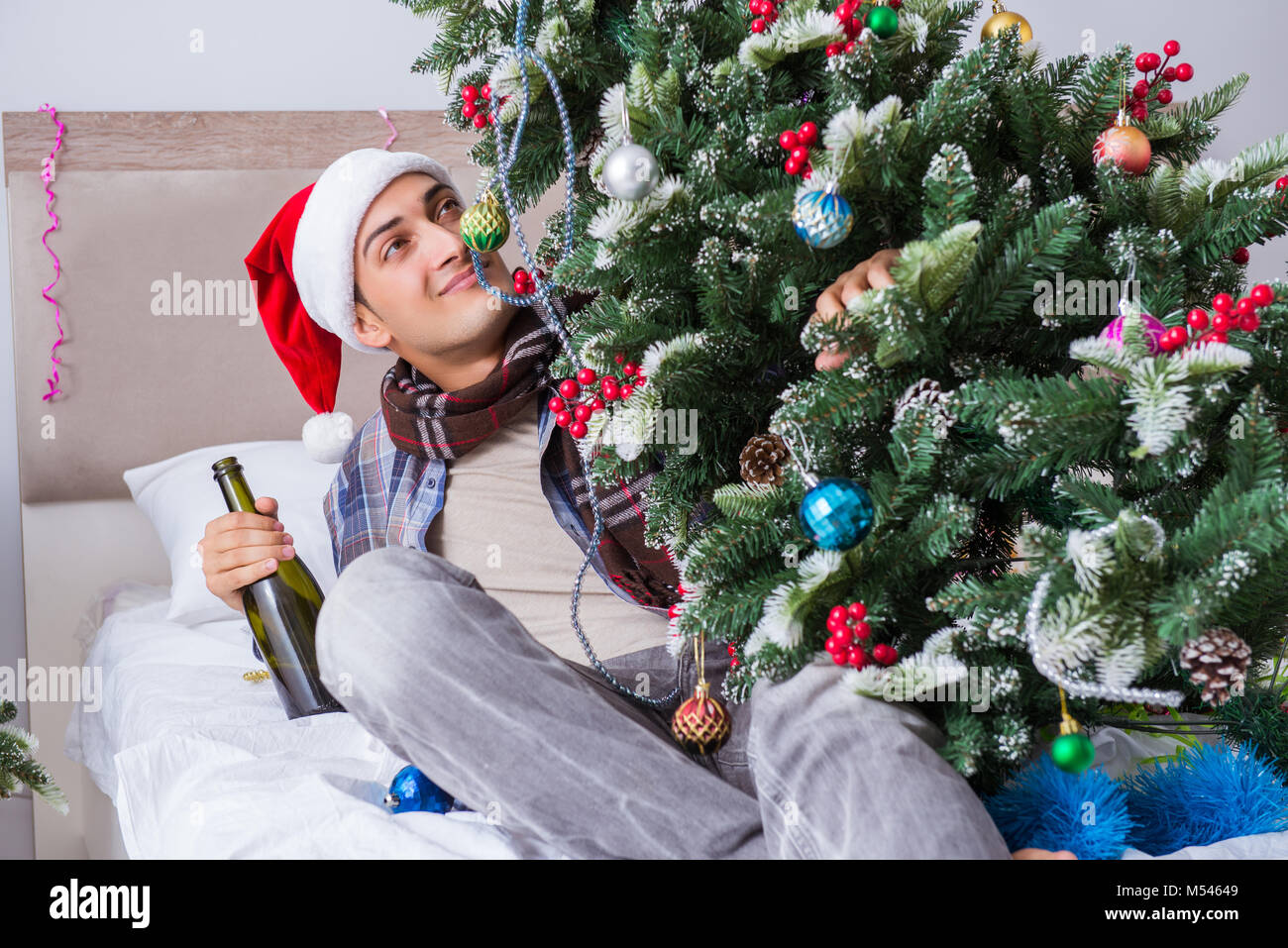 Man suffering hangover after christmas party Stock Photo - Alamy