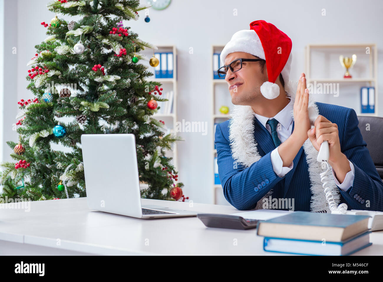 Businessman celebrating christmas holiday in the office Stock Photo - Alamy