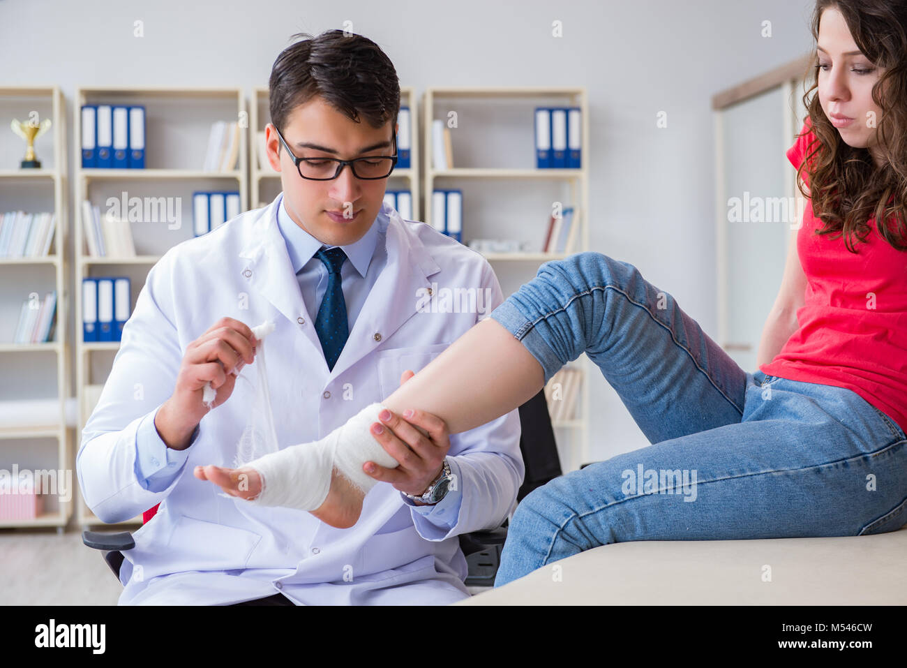 Doctor and patient during check-up for injury in hospital Stock Photo ...