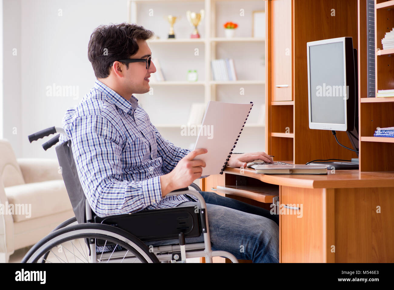 Disabled student studying at home on wheelchair Stock Photo - Alamy