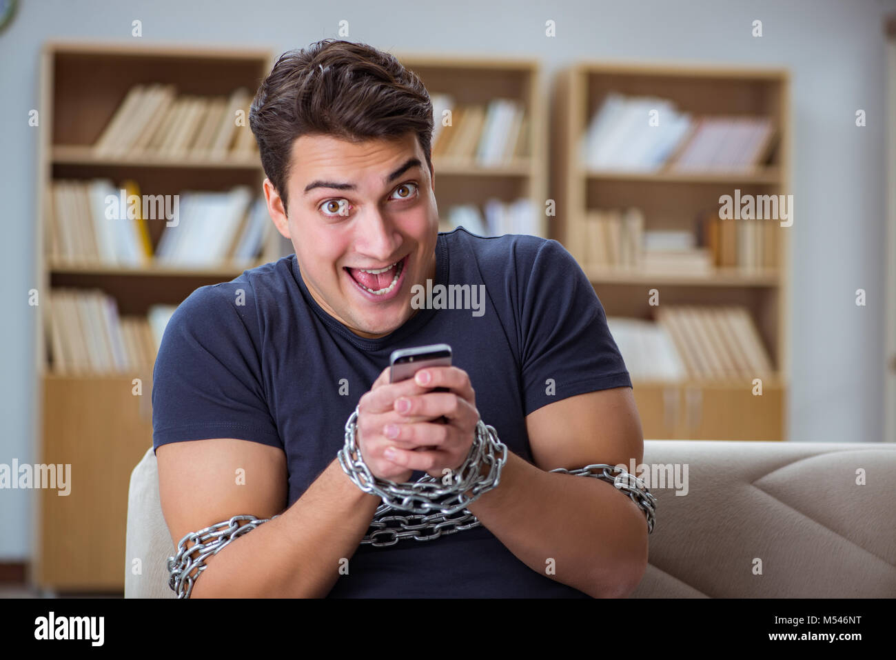 Man suffering from phone dependence addiction Stock Photo - Alamy