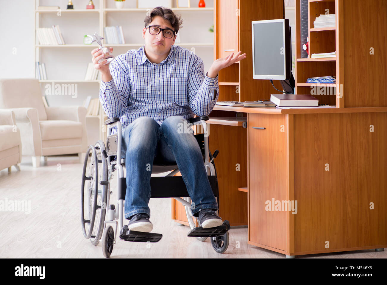 Disabled student studying at home on wheelchair Stock Photo - Alamy