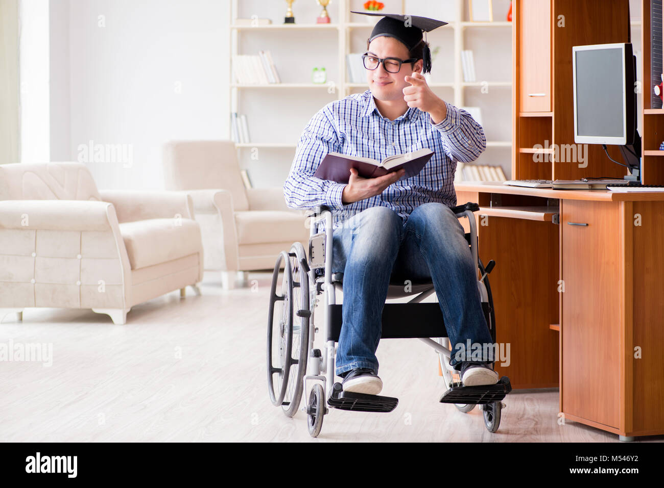 Disabled student studying at home on wheelchair Stock Photo - Alamy