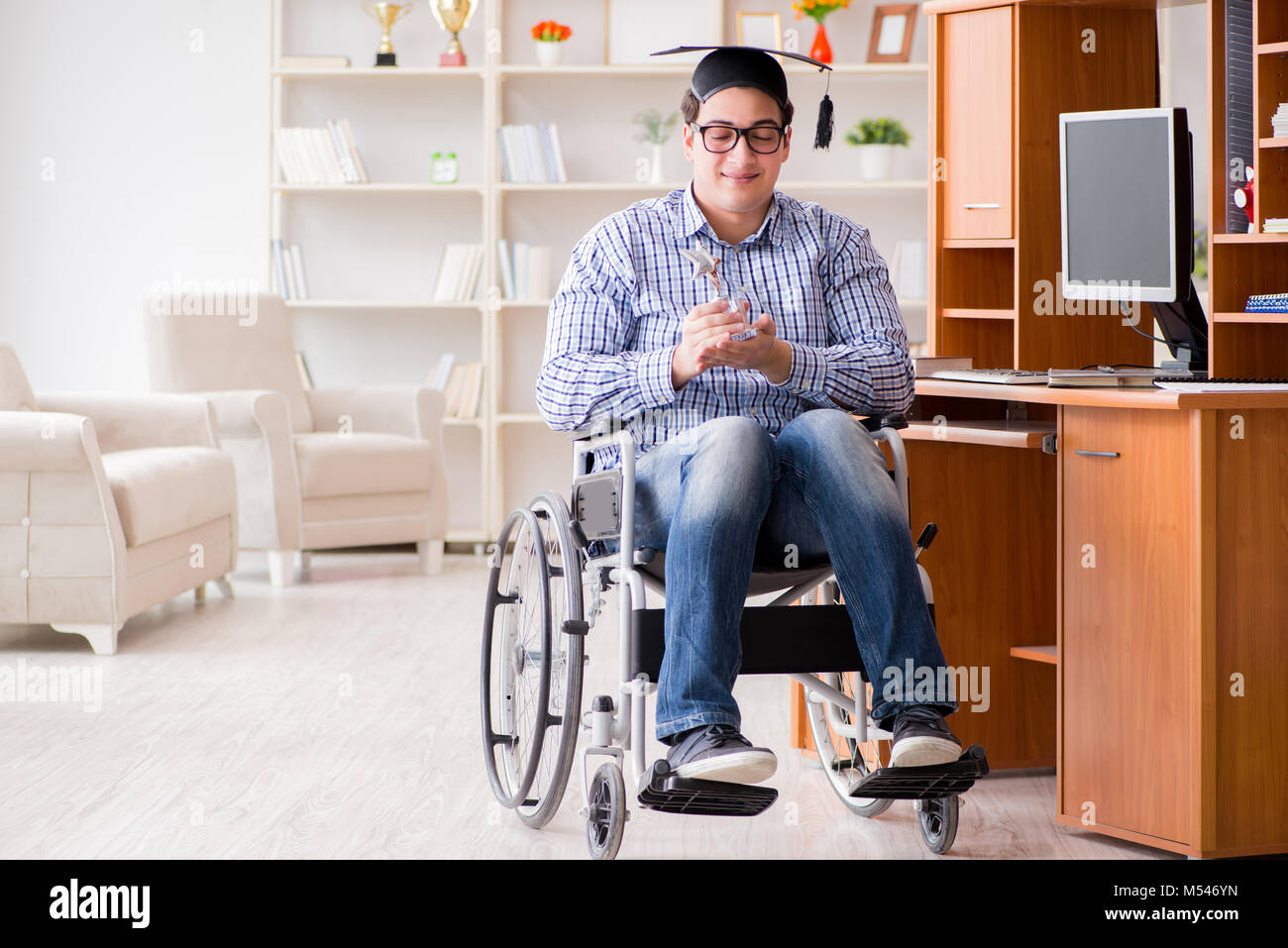 Disabled student studying at home on wheelchair Stock Photo - Alamy