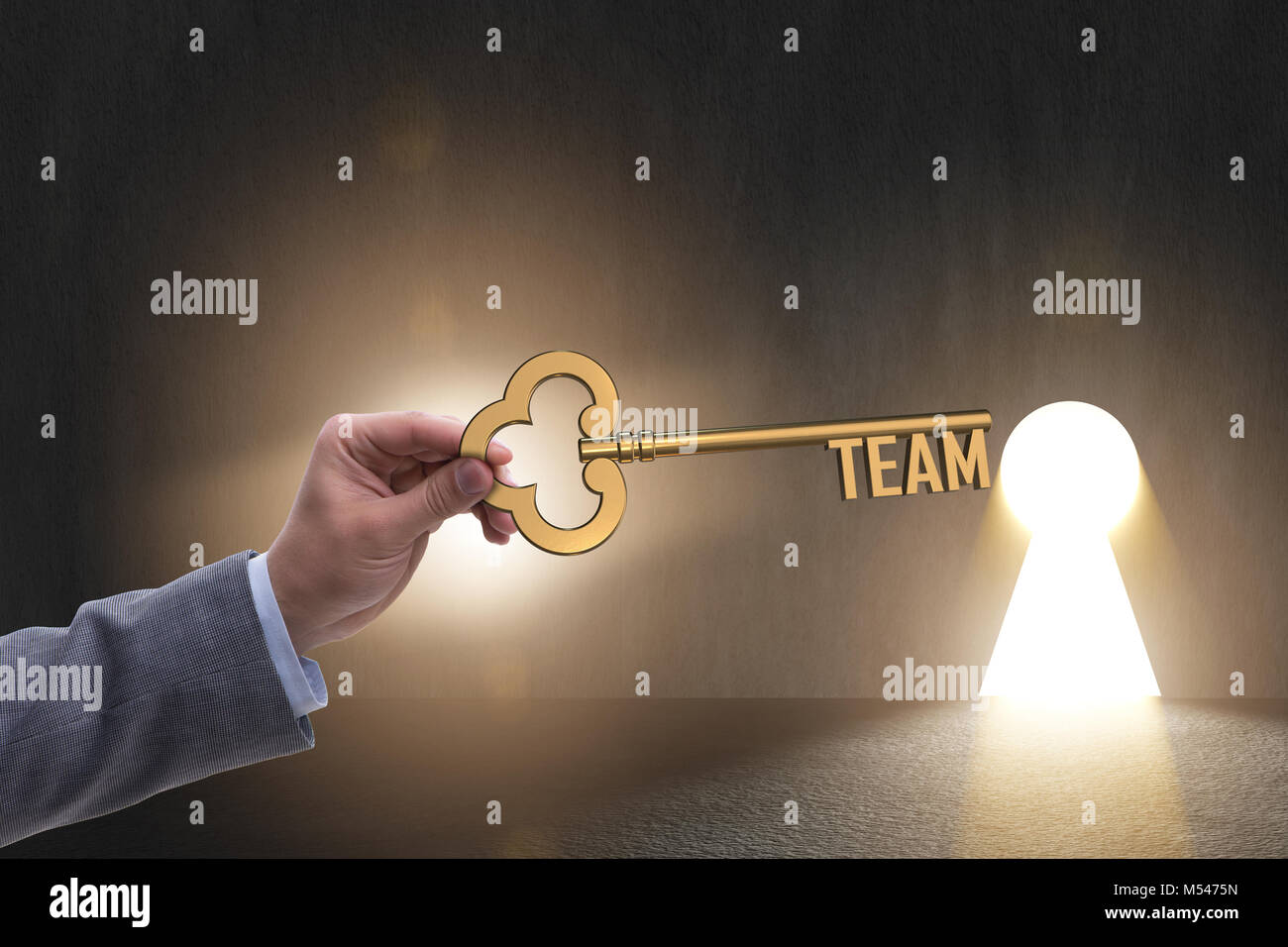 Businessman with key in teamwork concept Stock Photo - Alamy