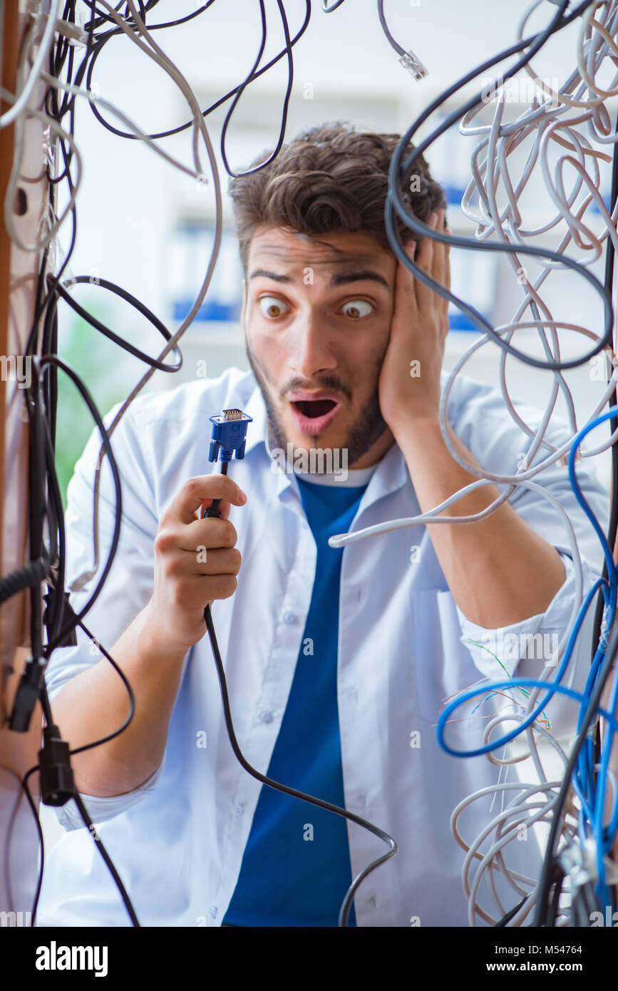 Electrician trying to untangle wires in repair concept Stock Photo - Alamy