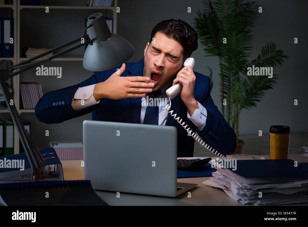 Employee working late to finish important deliverable task Stock Photo ...