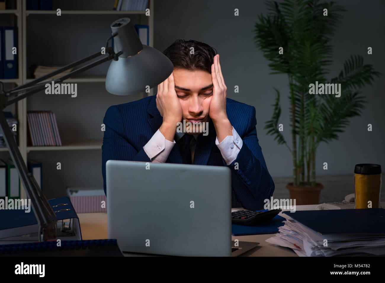 Employee working late to finish important deliverable task Stock Photo ...