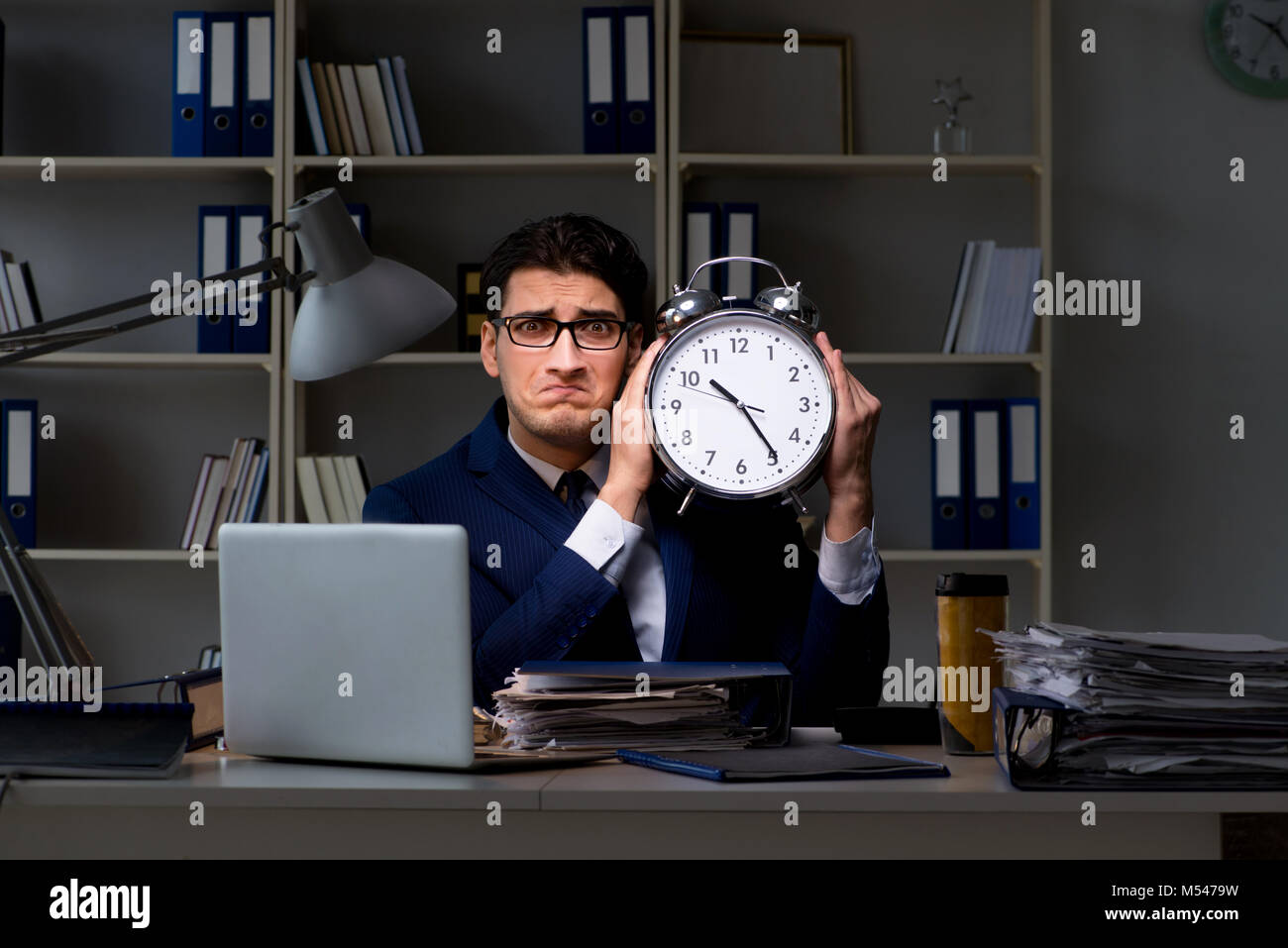 Employee staying late to finish work on auditing Stock Photo - Alamy