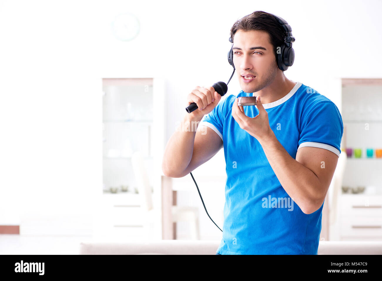 Young man singing at home karaoke Stock Photo - Alamy