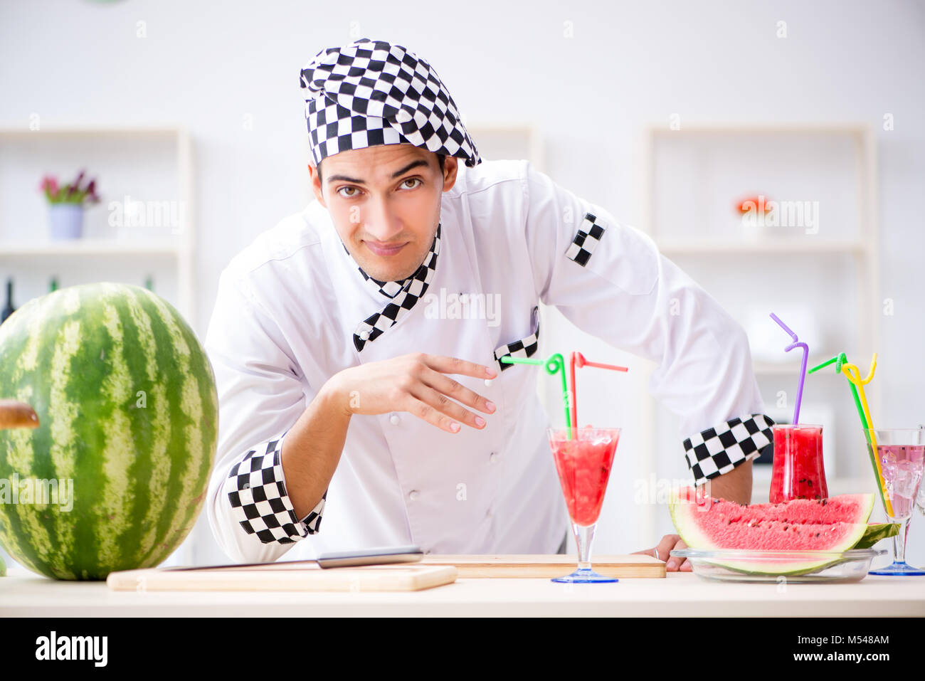Male cook with watermelon in kitchen Stock Photo - Alamy