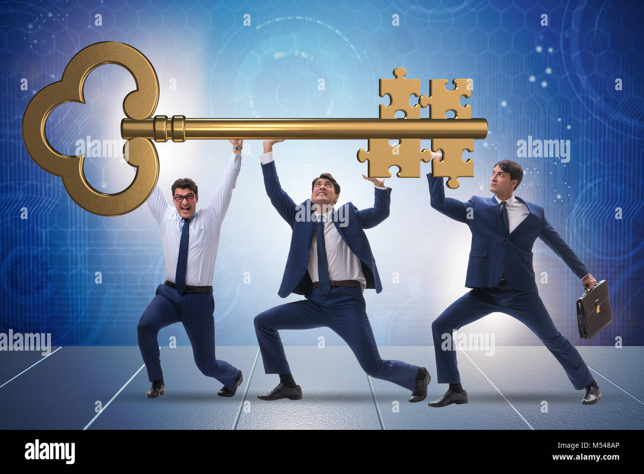 Businessmen holding giant key in business concept Stock Photo - Alamy