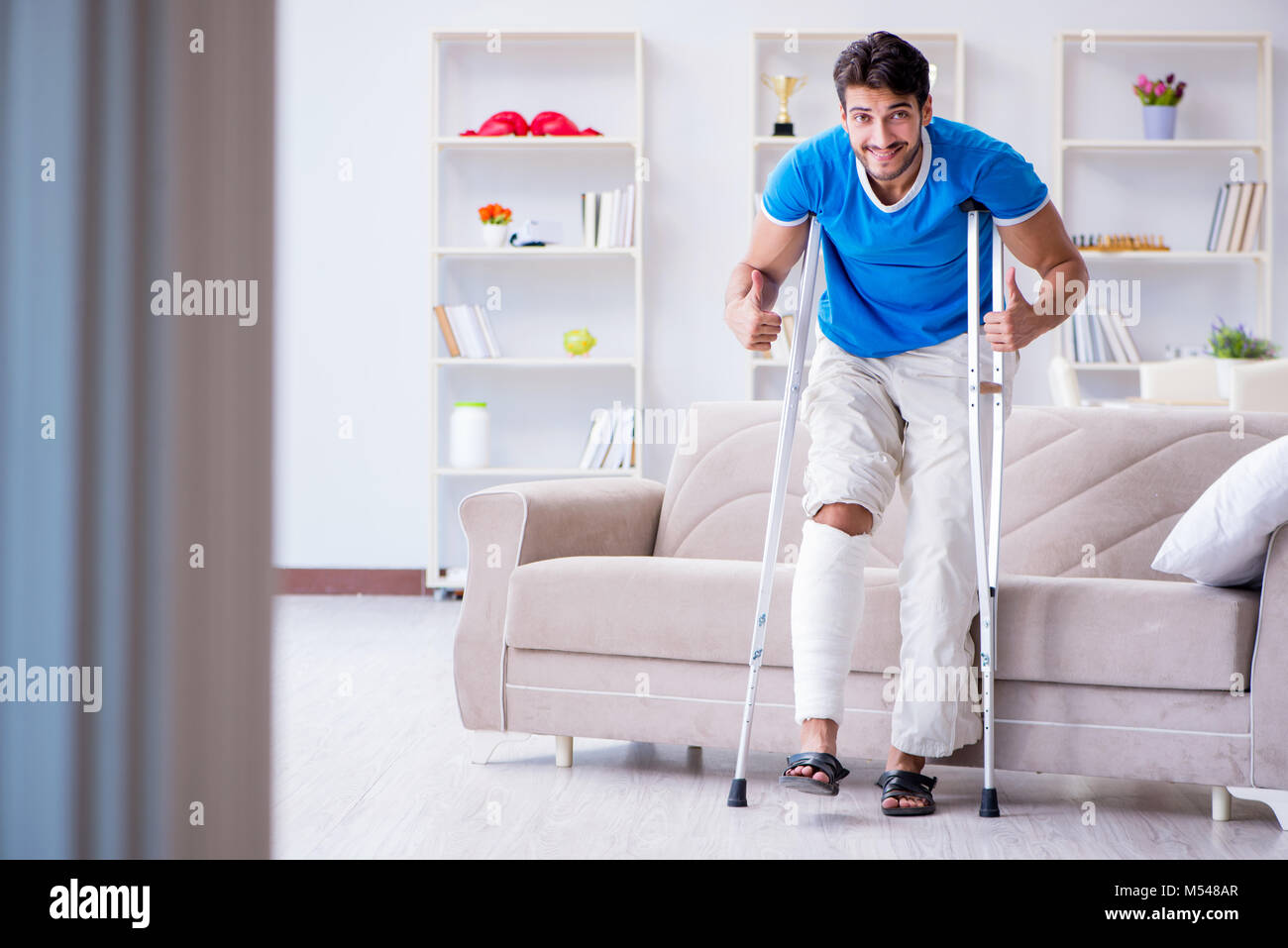 Injured young man recovering at home Stock Photo - Alamy