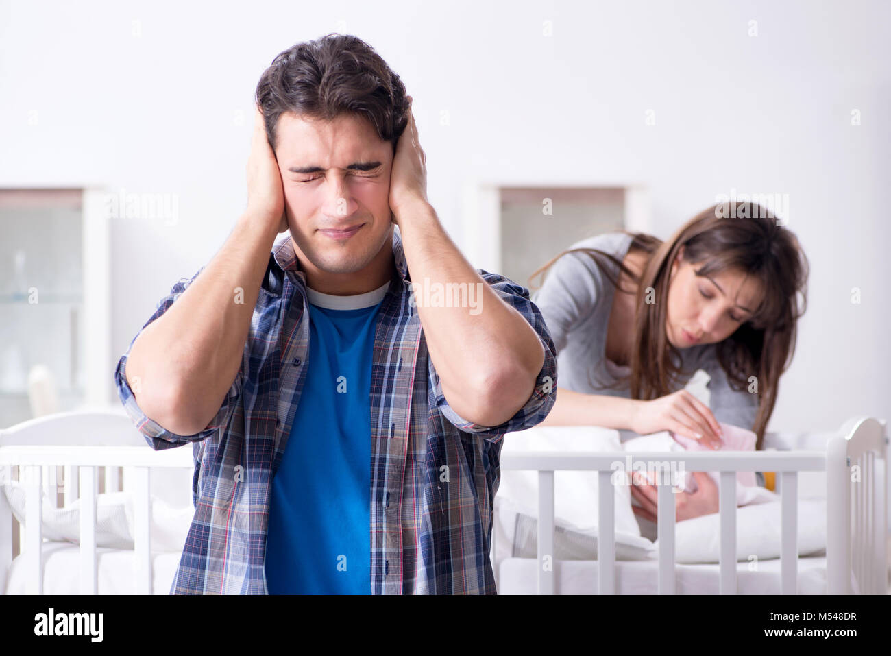Young dad cannot stand baby crying Stock Photo - Alamy