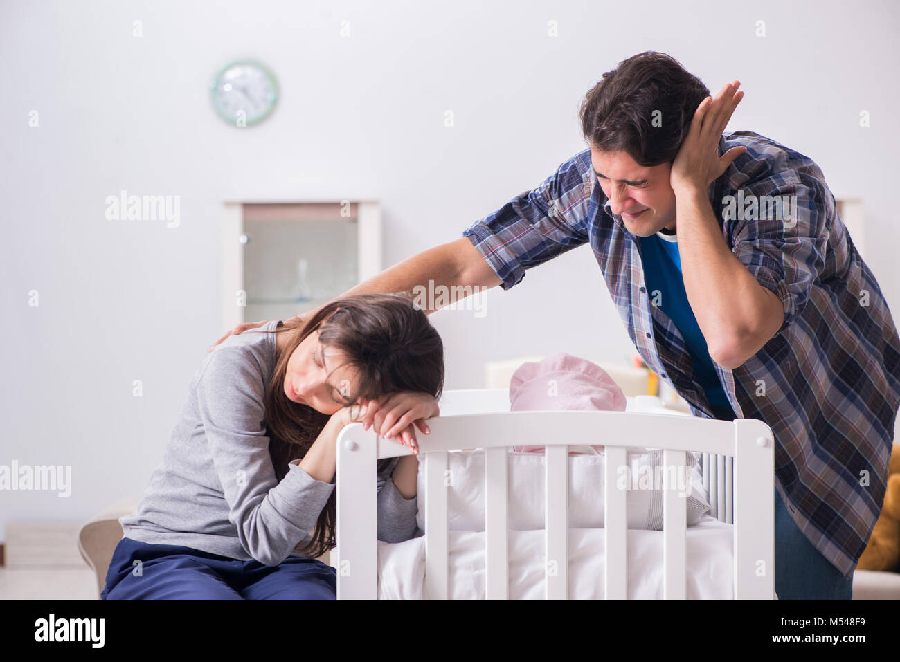 Young dad cannot stand baby crying Stock Photo - Alamy
