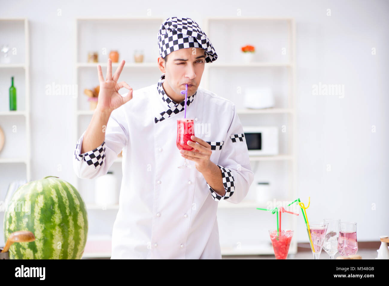 Male cook with watermelon in kitchen Stock Photo - Alamy