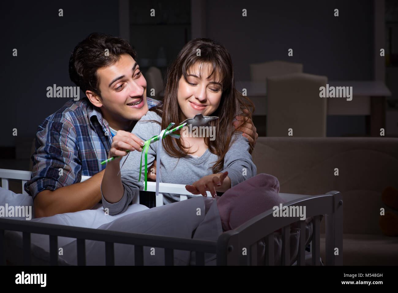 Young parents sleepless with newborn baby at night Stock Photo - Alamy