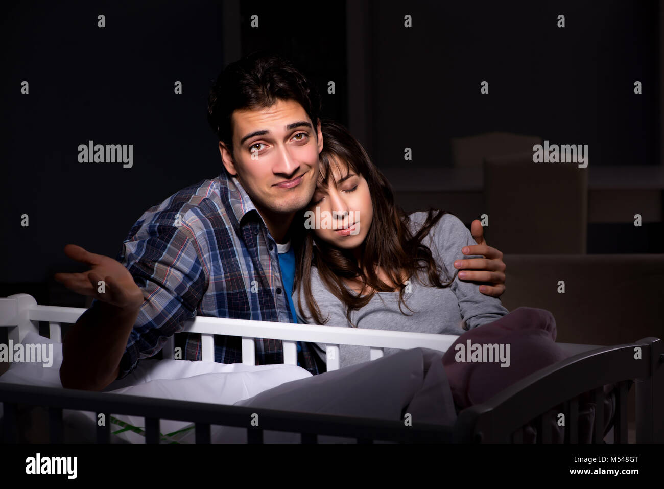 Young parents sleepless with newborn baby at night Stock Photo - Alamy