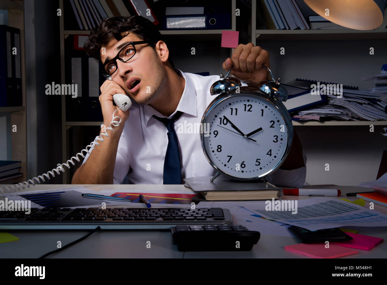 Man businessman working late hours in the office Stock Photo - Alamy