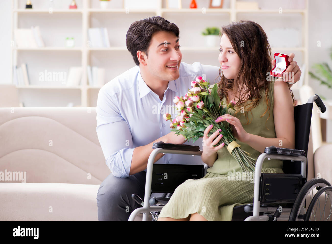 Man making marriage proposal to disabled woman on wheelchair Stock ...