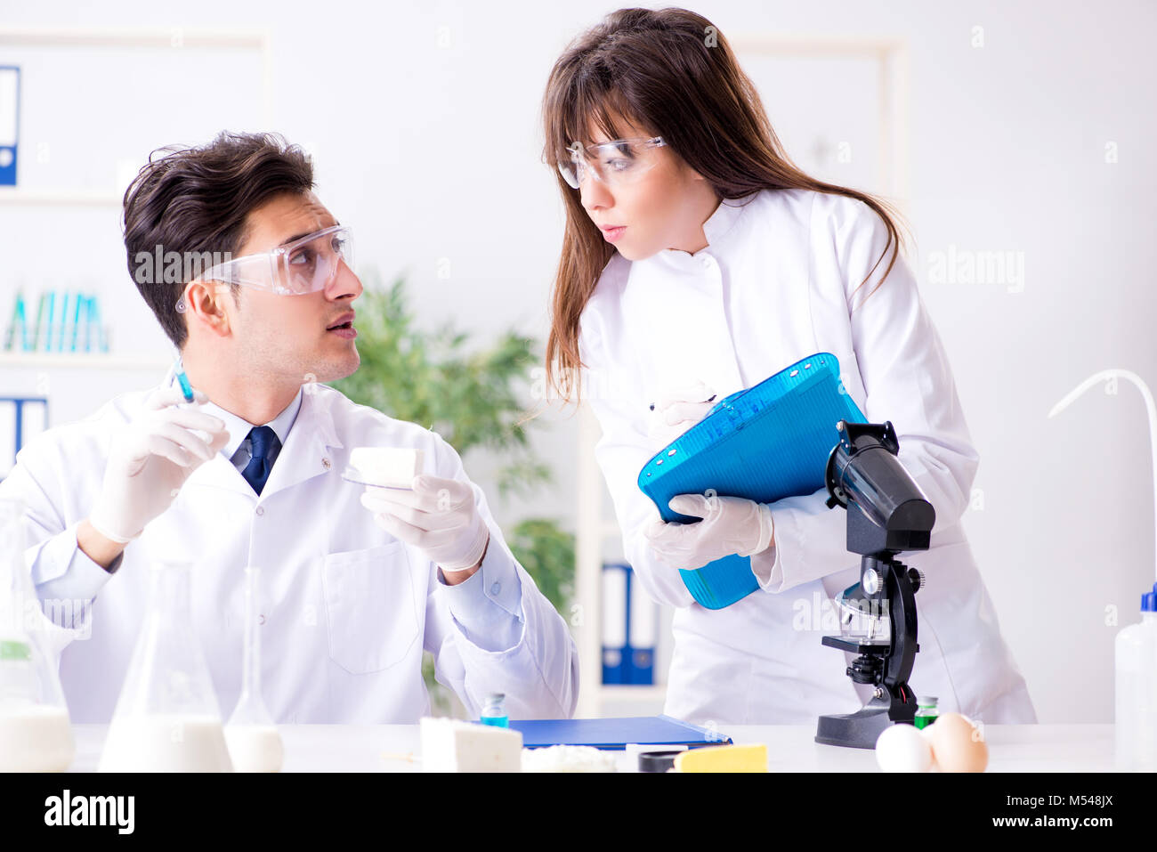 Two lab doctor testing food products Stock Photo - Alamy