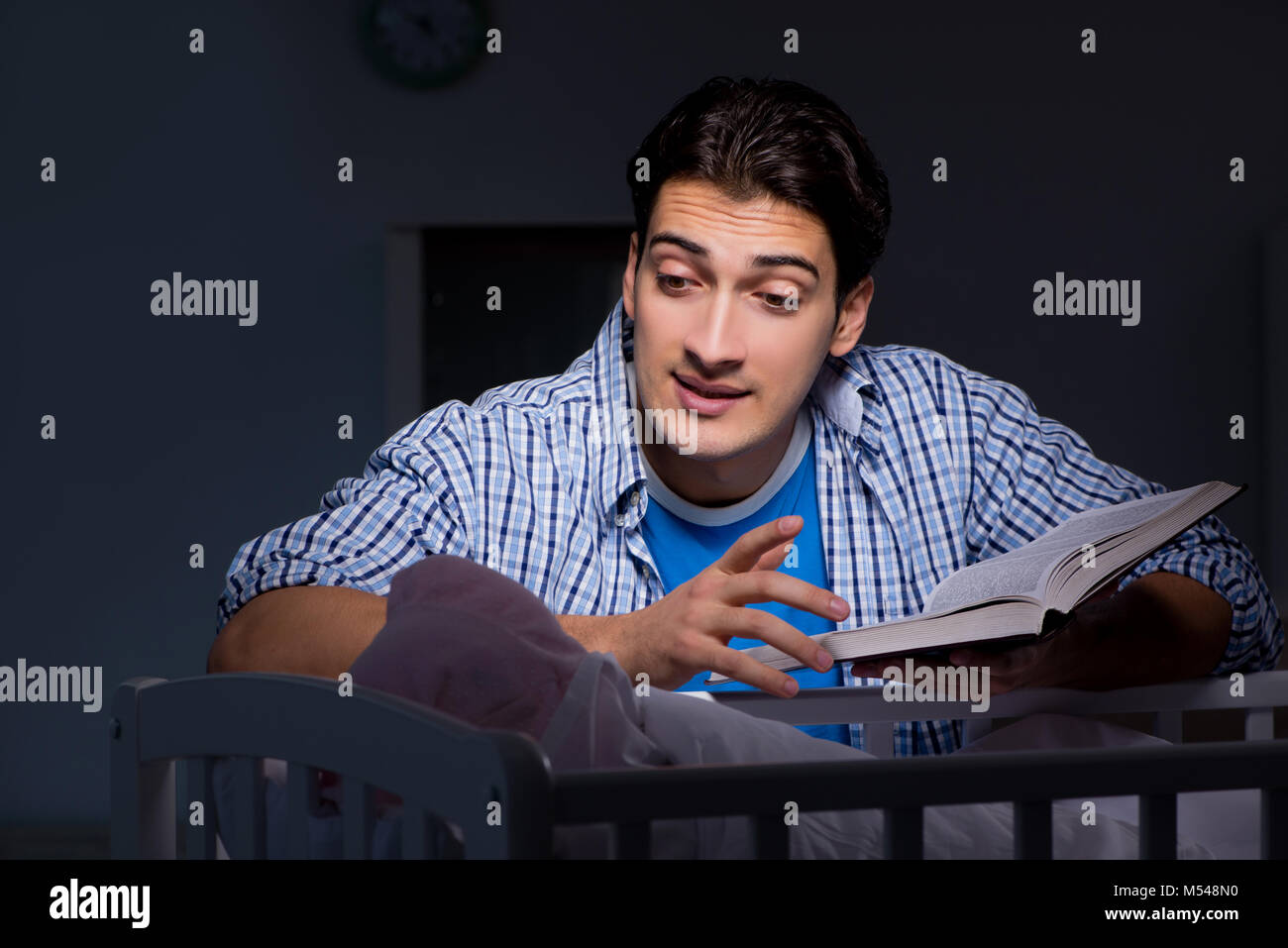 Young student doing homework and looking after newborn baby Stock Photo ...