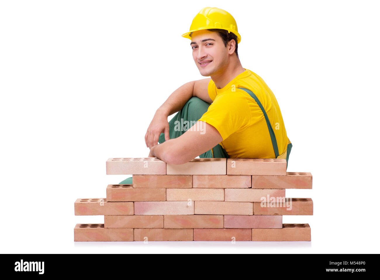 The handsome construction worker building brick wall Stock Photo - Alamy