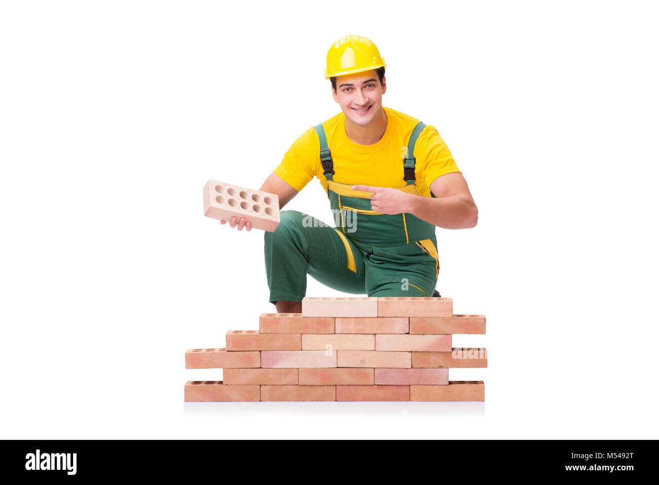 The handsome construction worker building brick wall Stock Photo - Alamy