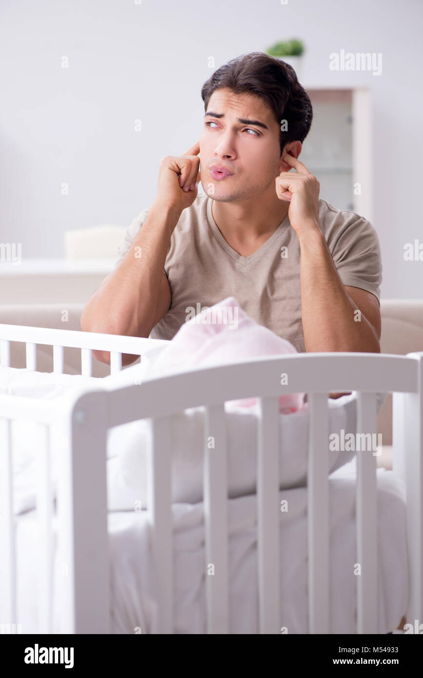 Young father dad frustrated at crying baby Stock Photo - Alamy