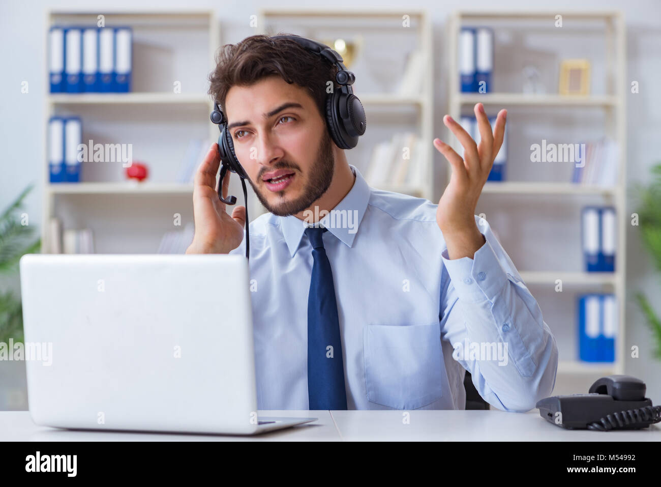 Call center employee working in office Stock Photo - Alamy