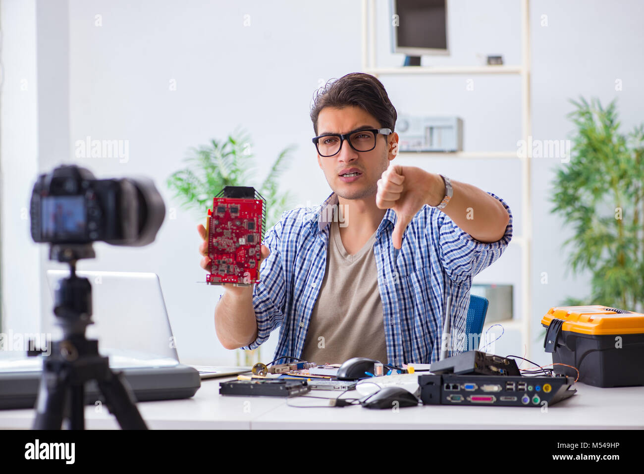 Vlogger recording computer repair on camera for vlog blog Stock Photo ...