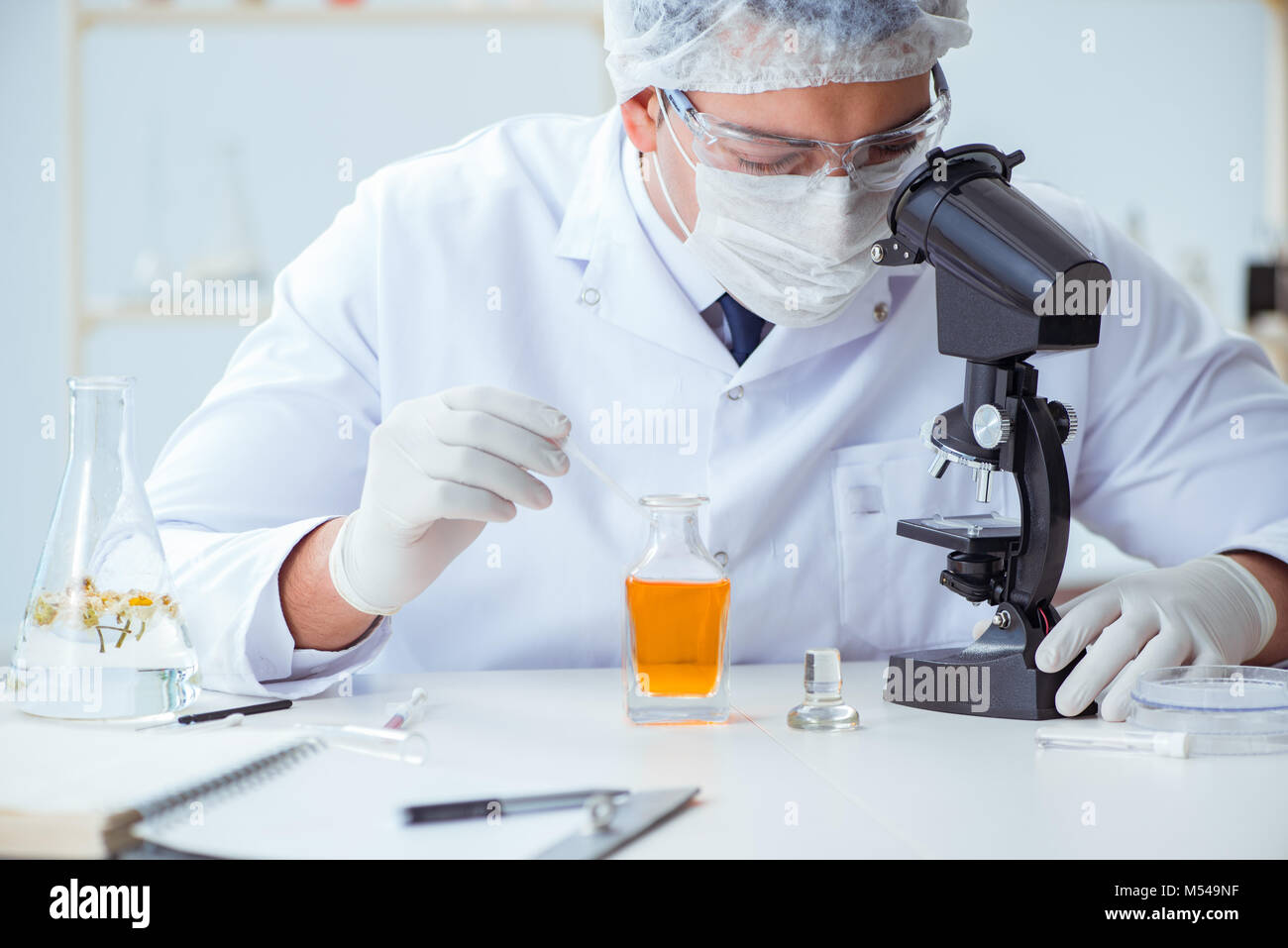 Chemist mixing perfumes in the lab Stock Photo - Alamy