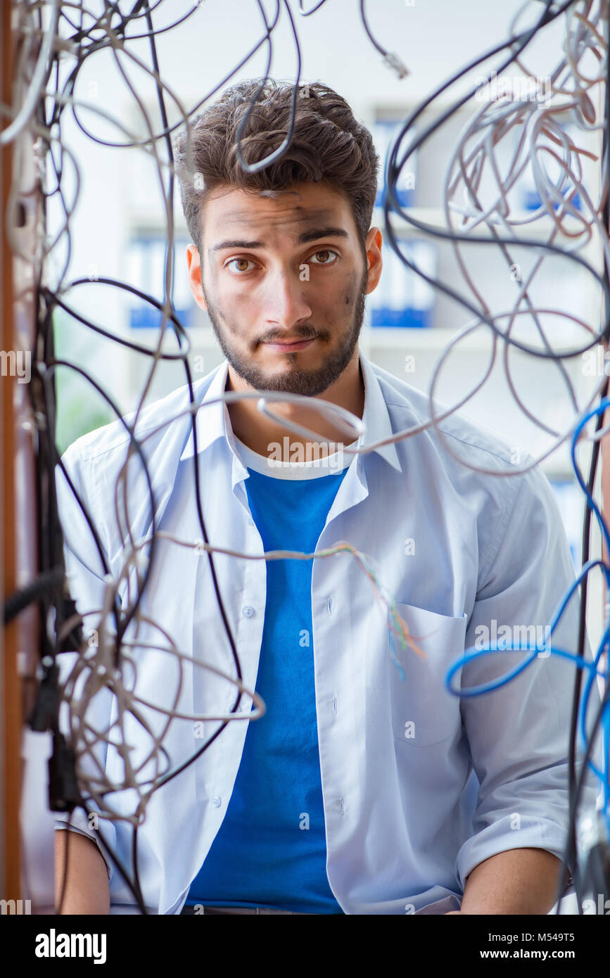 Electrician trying to untangle wires in repair concept Stock Photo - Alamy
