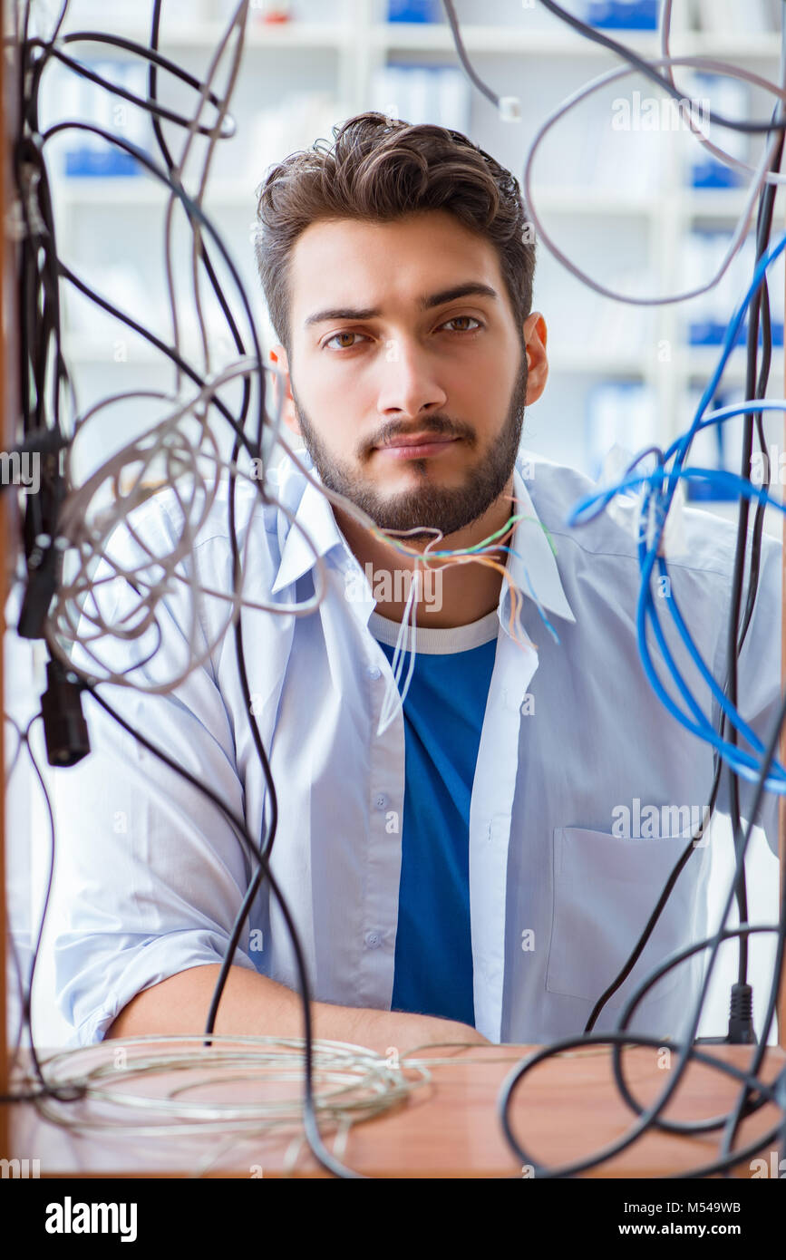 Electrician trying to untangle wires in repair concept Stock Photo - Alamy