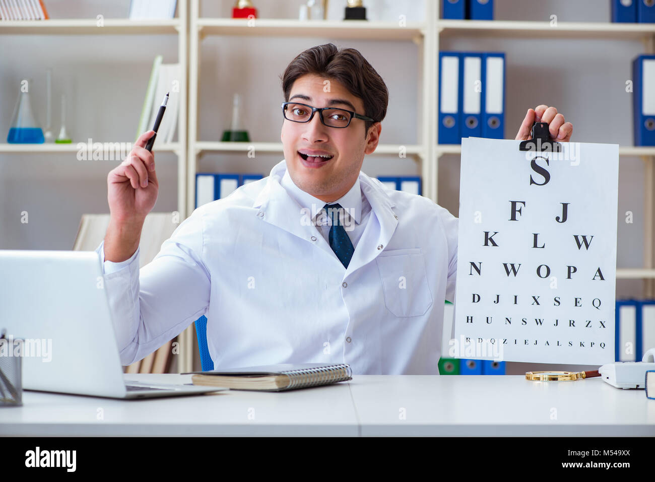 Doctor optician with letter chart conducting an eye test check Stock ...