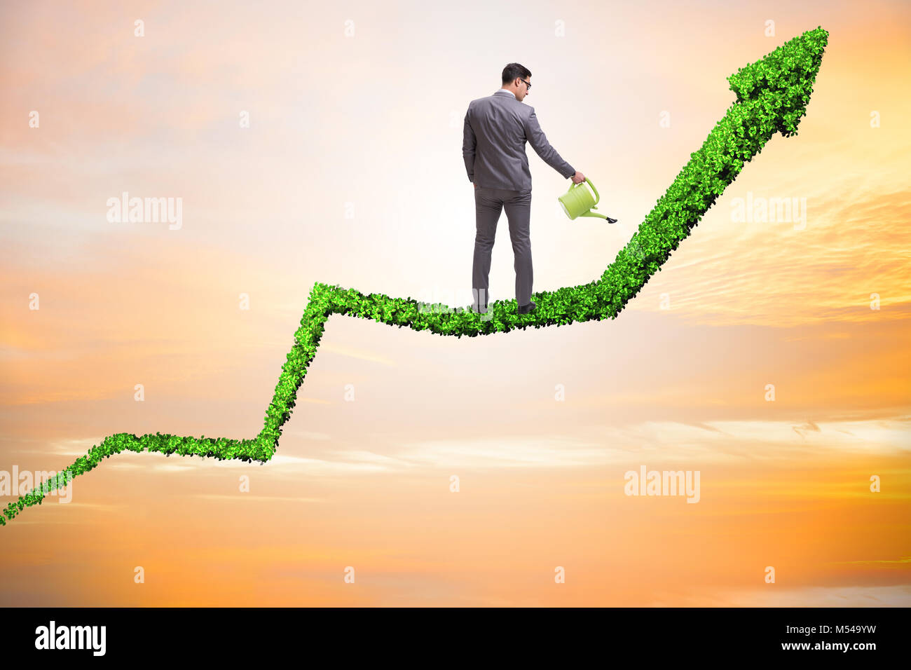 Businessman in investment concept watering financial line chart Stock ...
