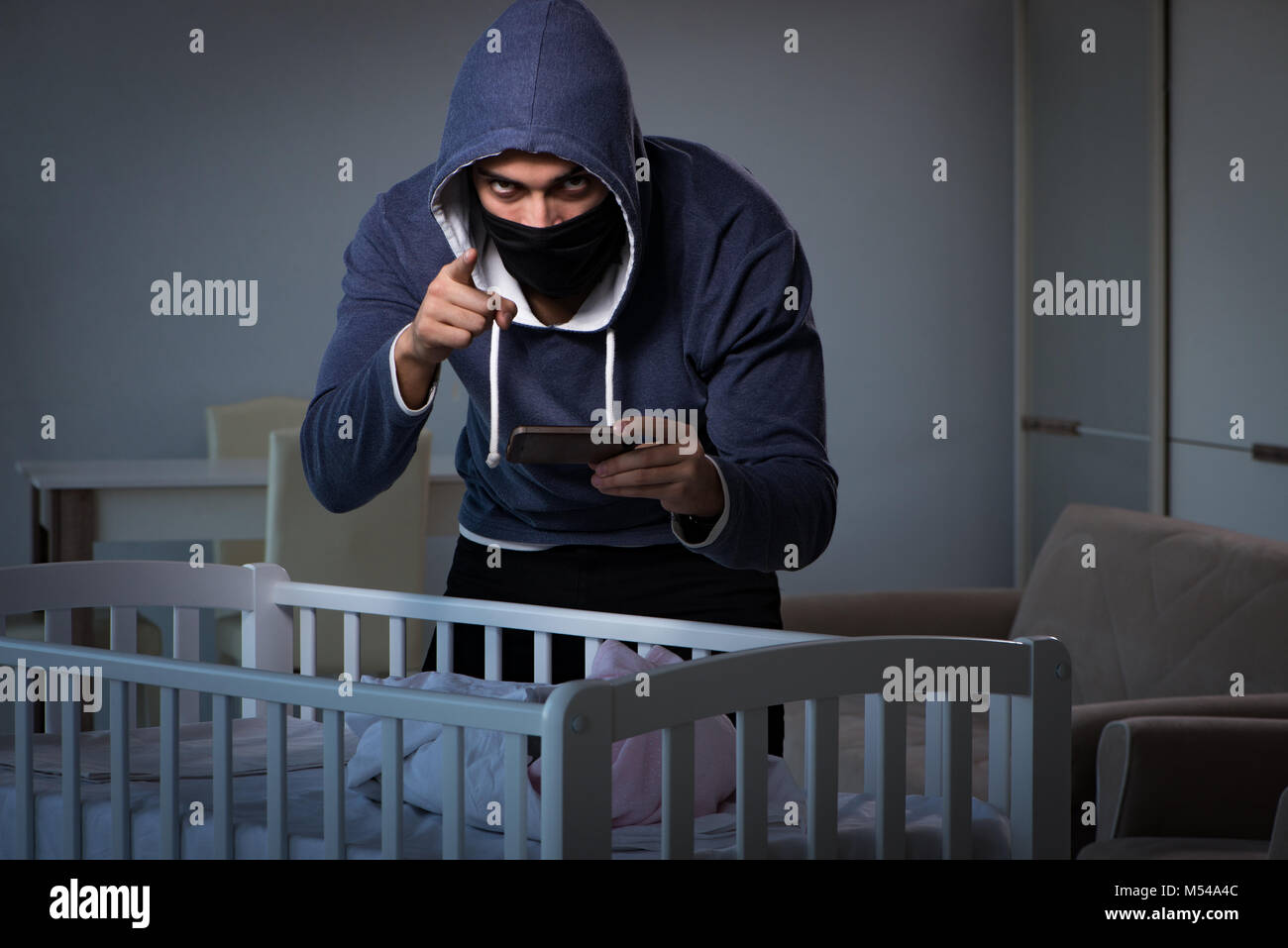 Criminal stealing baby in human child traficking concept Stock Photo ...