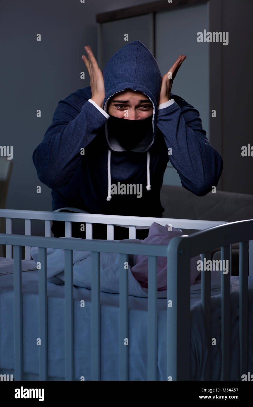 Criminal stealing baby in human child traficking concept Stock Photo ...