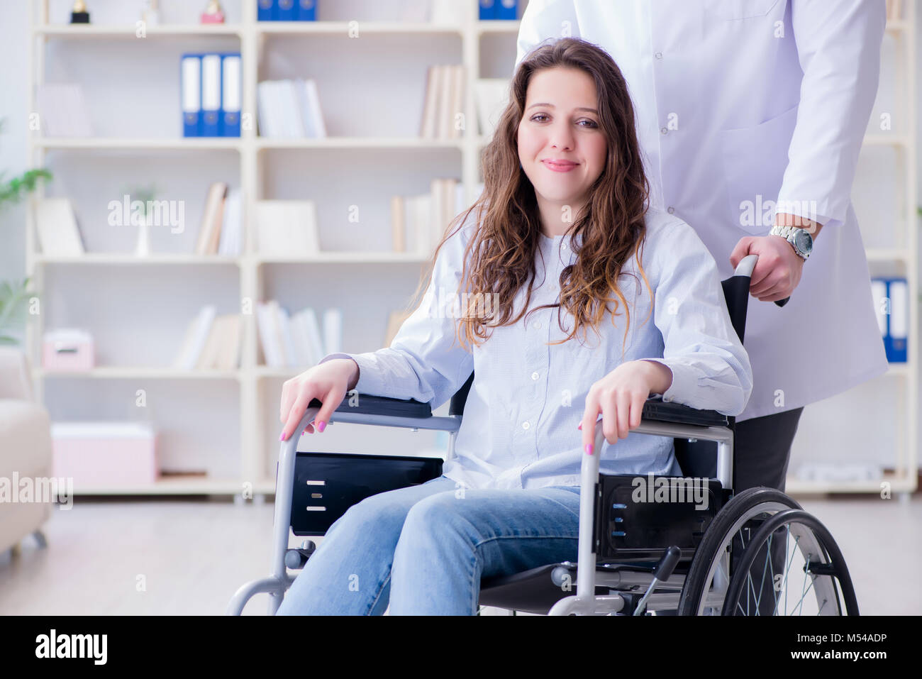 Disabled patient on wheelchair visiting doctor for regular check up ...