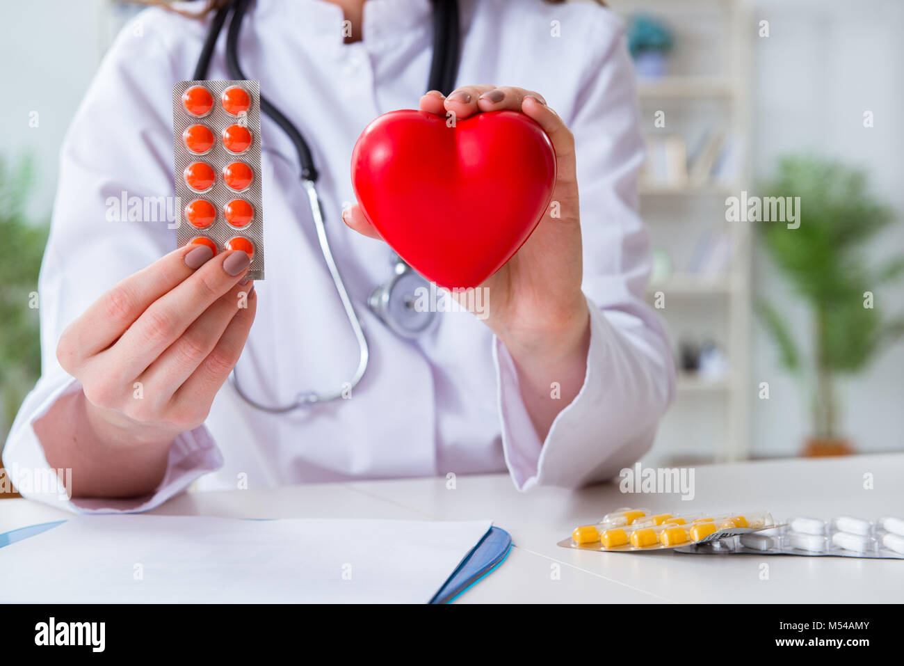Doctor cardiologist with red heart in the hospital Stock Photo - Alamy