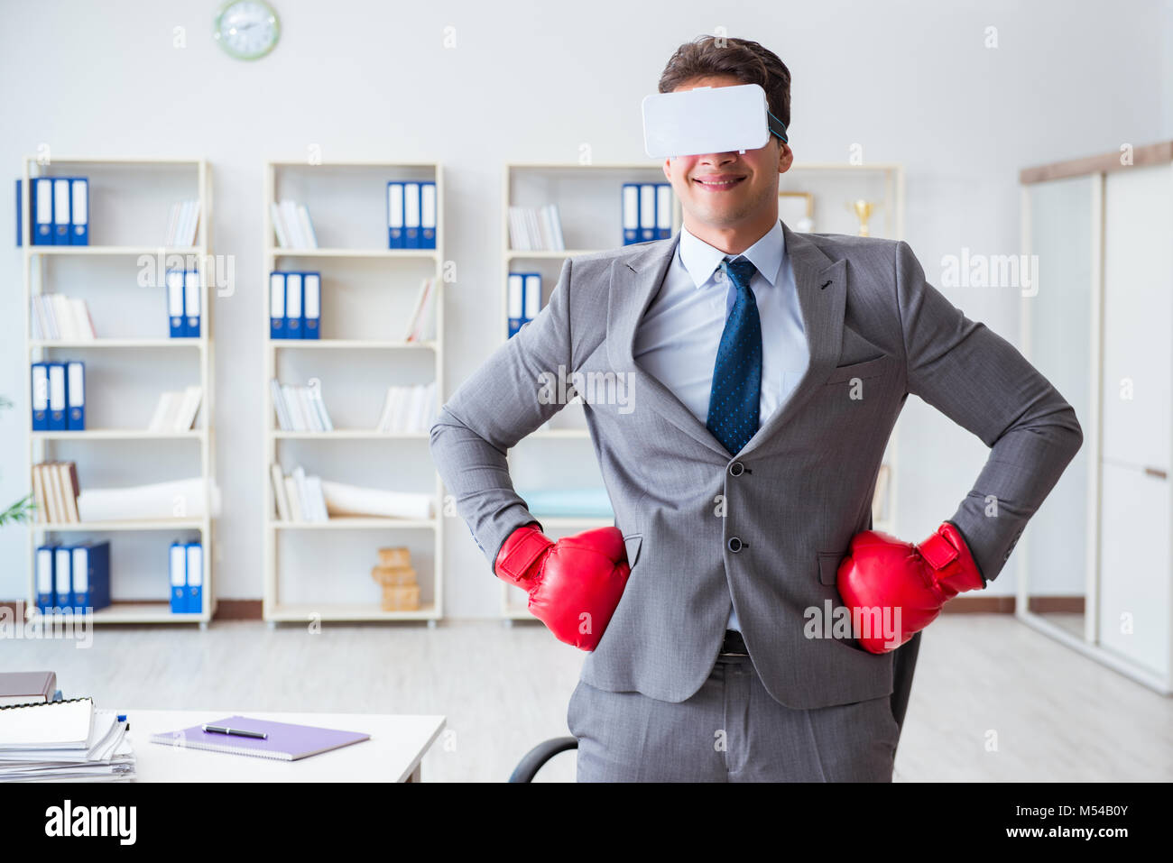 Man boxing in the office with virtual reality goggles Stock Photo - Alamy