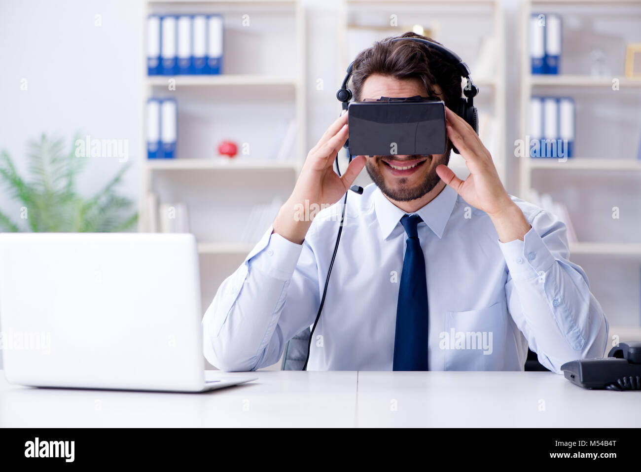 Businessman gamer in office playing games Stock Photo - Alamy