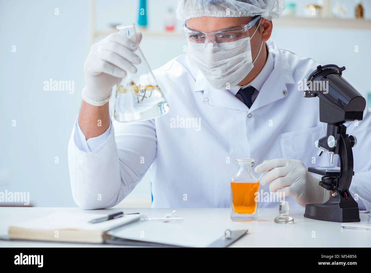 Chemist mixing perfumes in the lab Stock Photo - Alamy