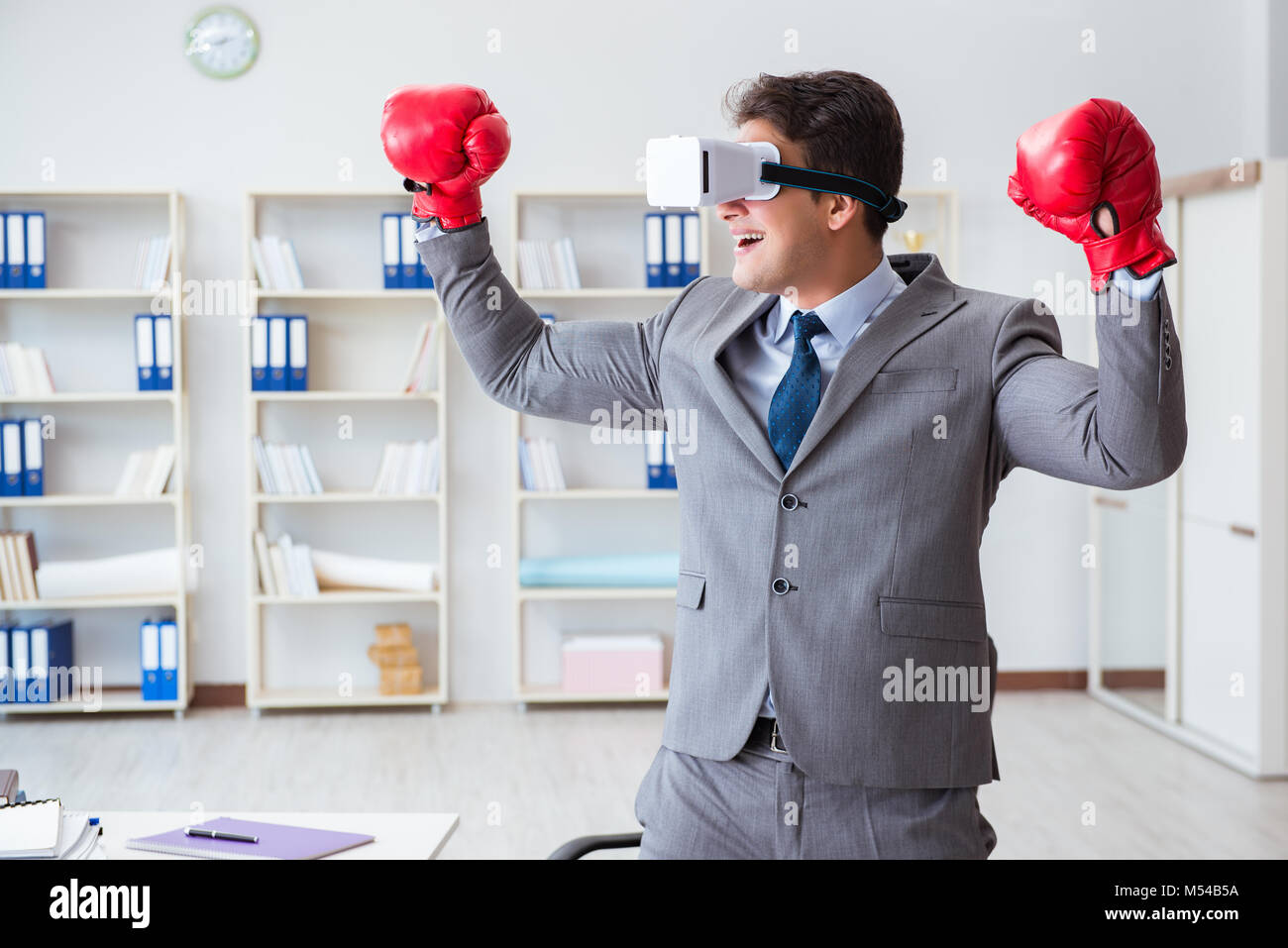 Man boxing in the office with virtual reality goggles Stock Photo - Alamy