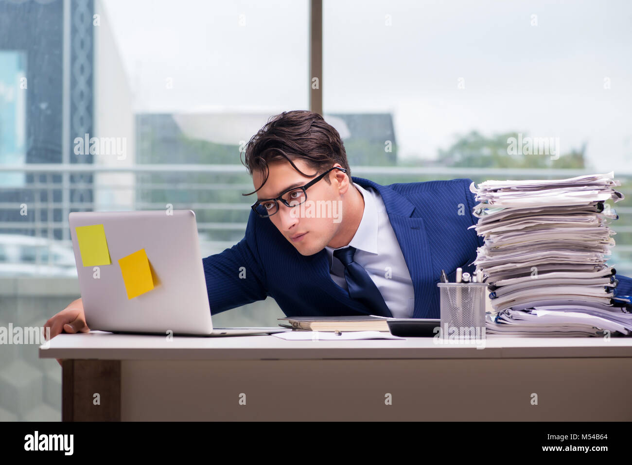 Workaholic businessman overworked with too much work in office Stock ...