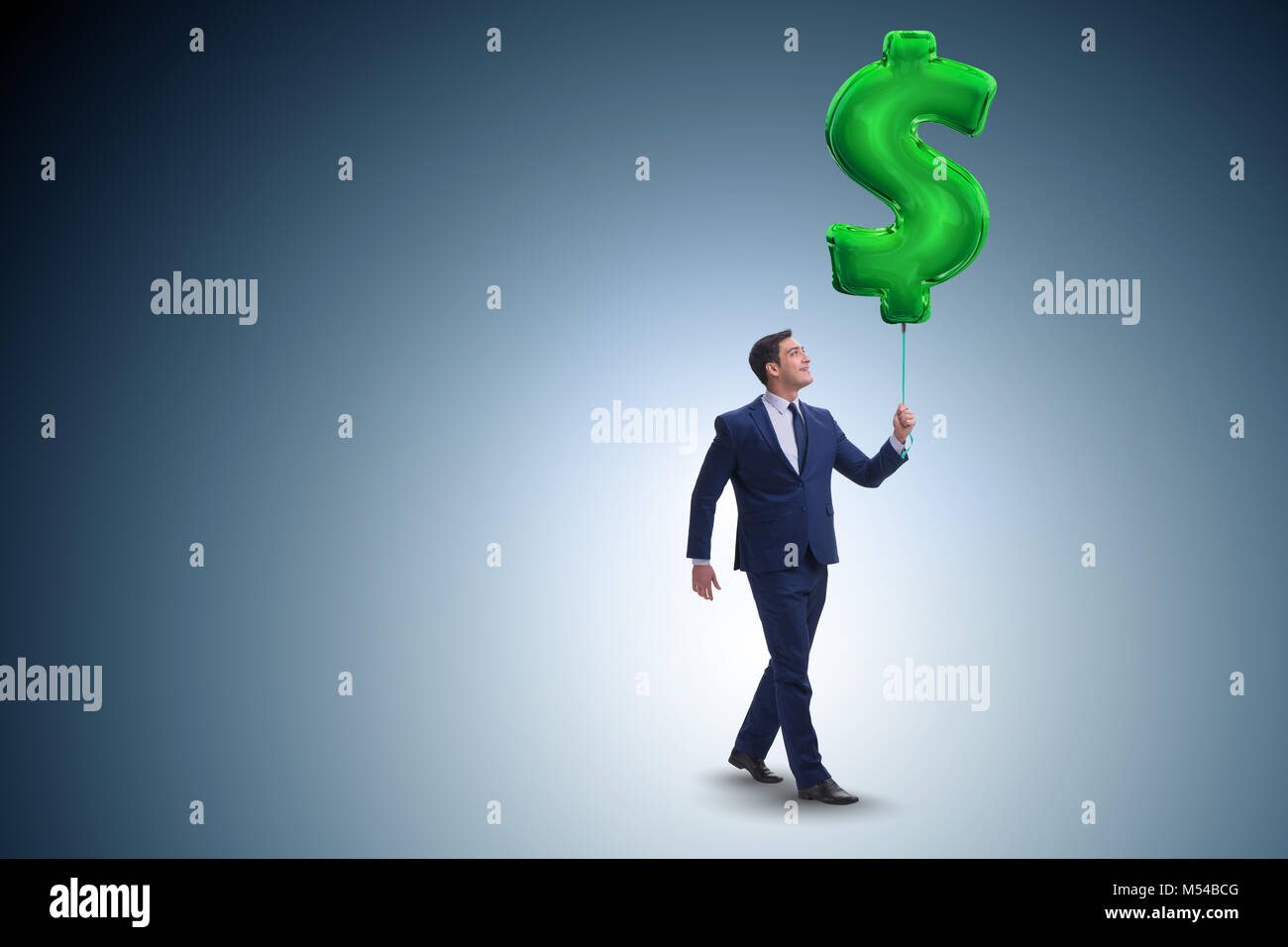 Businessman walking with inflatable dollar sign Stock Photo - Alamy