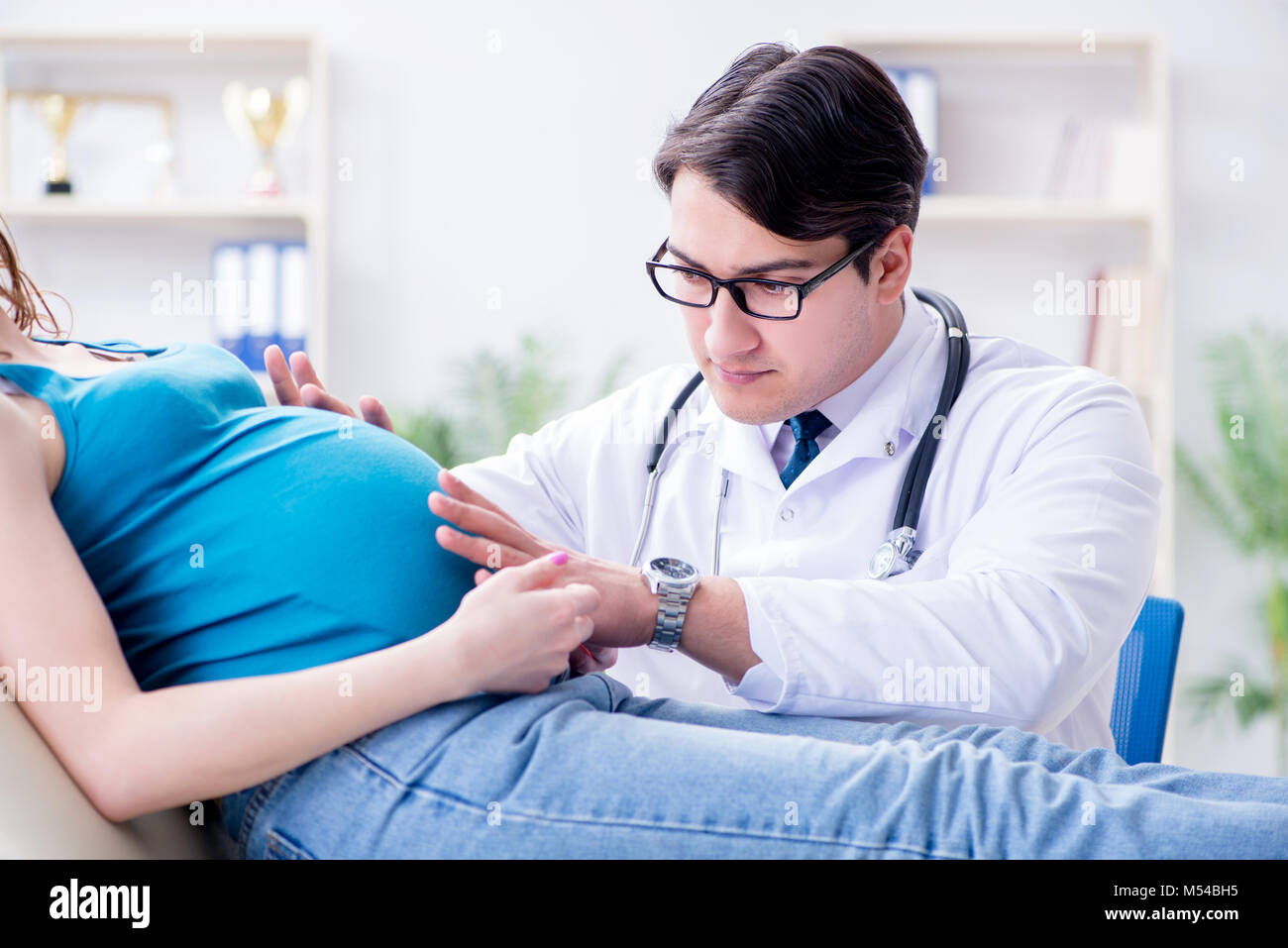 Doctor examining pregnant female patient in hospital Stock Photo - Alamy