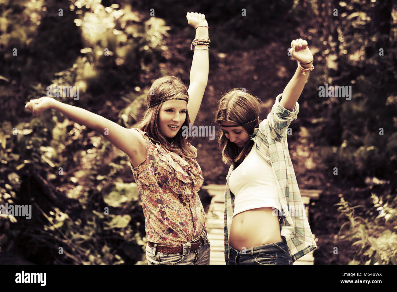 Two happy teen girls in a summer forest Stock Photo - Alamy